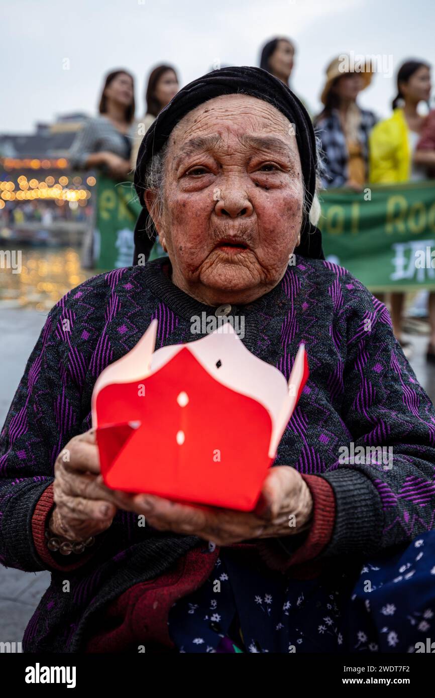 Old poor woman is selling lantern and candles in Hoi An Vietnam Stock ...