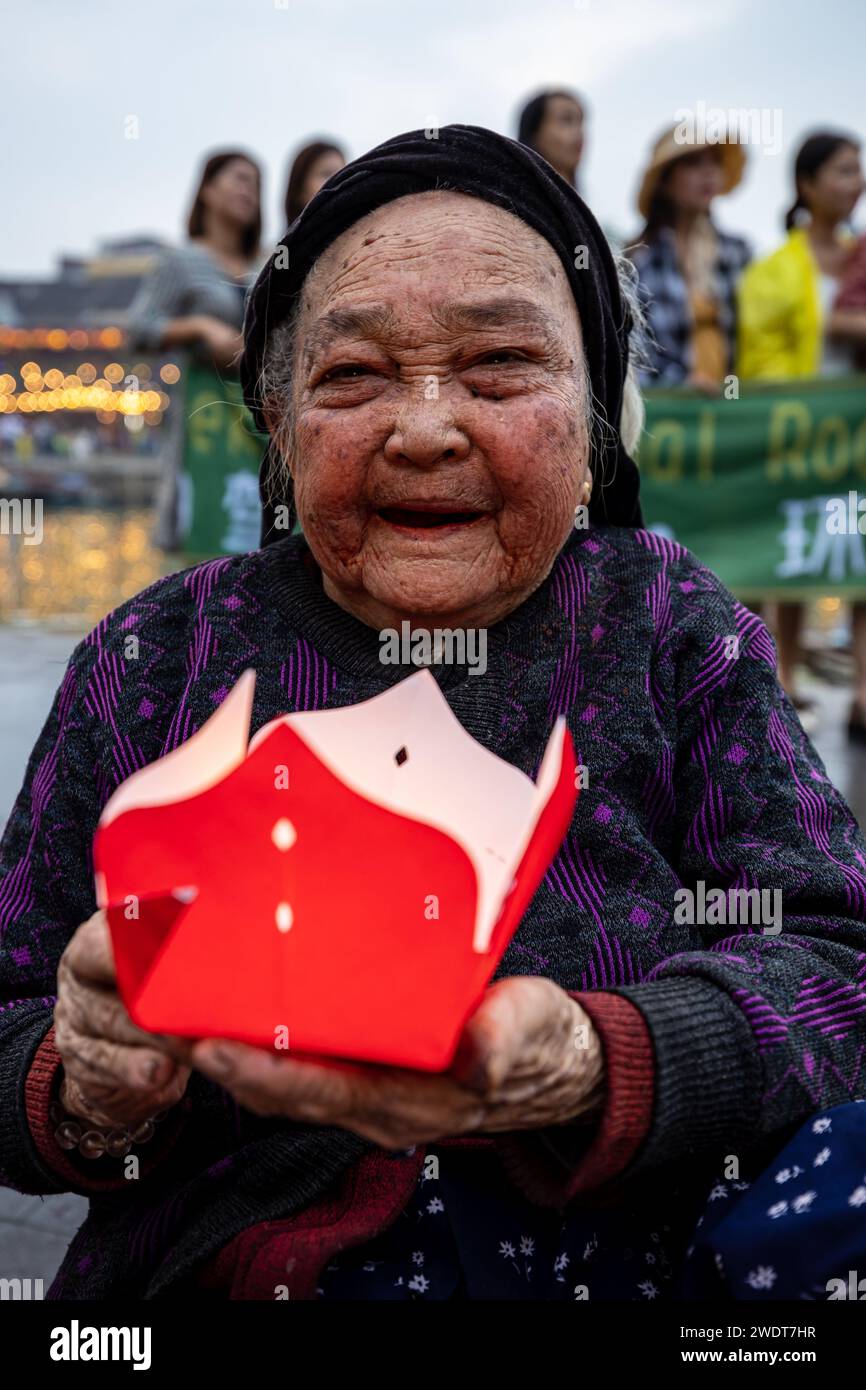 Old poor woman is selling lantern and candles in Hoi An Vietnam Stock ...