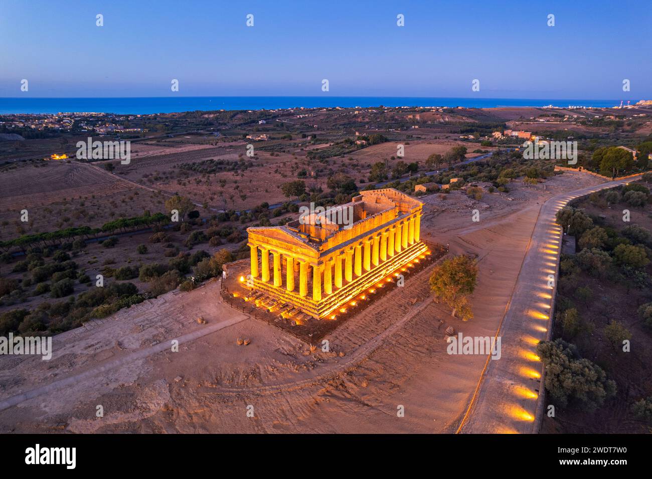 The illuminated Temple of Concordia seen from a drone at dawn, Valley ...