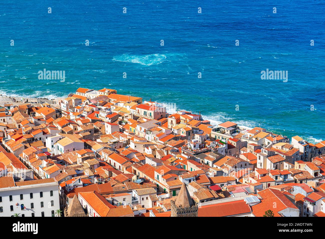 The old fishing village of Cefalu with red roofs and white houses seen ...