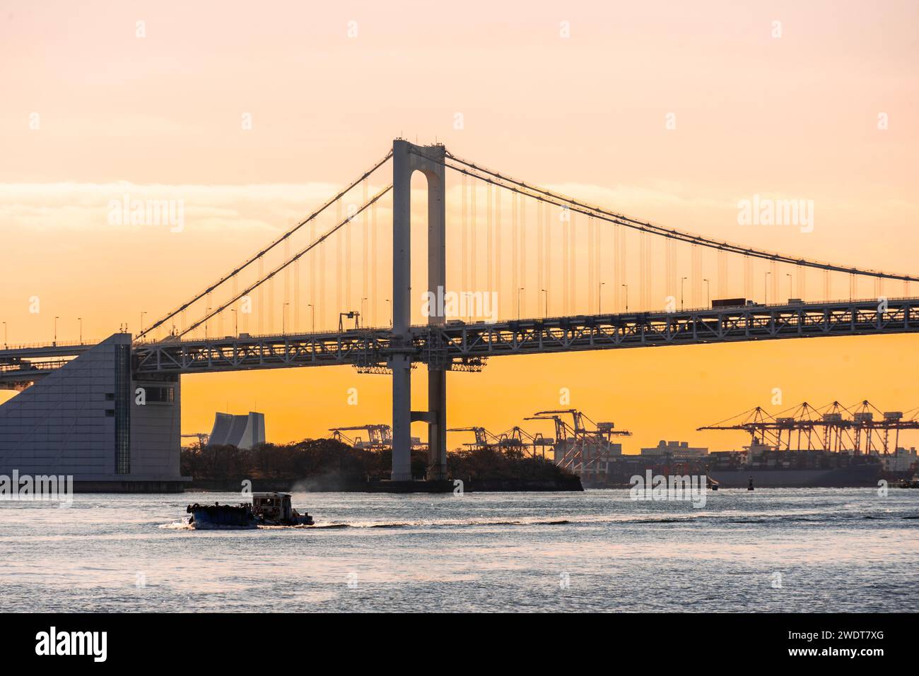 View from River Sumida at sunrise, Tokyo Rainbow bridge and cranes of ...