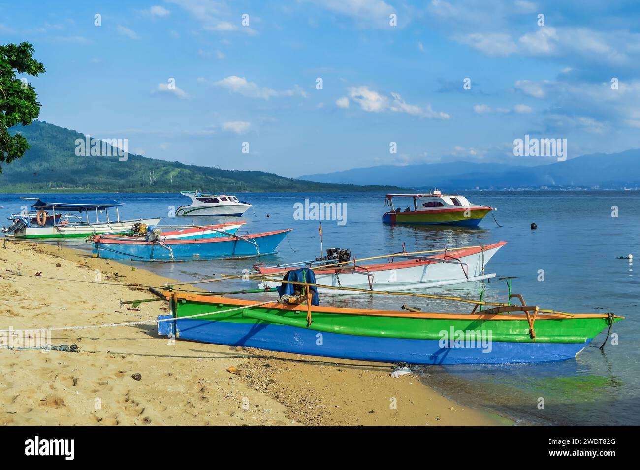 Outrigger canoes and launches at this coral fringed holiday island and ...