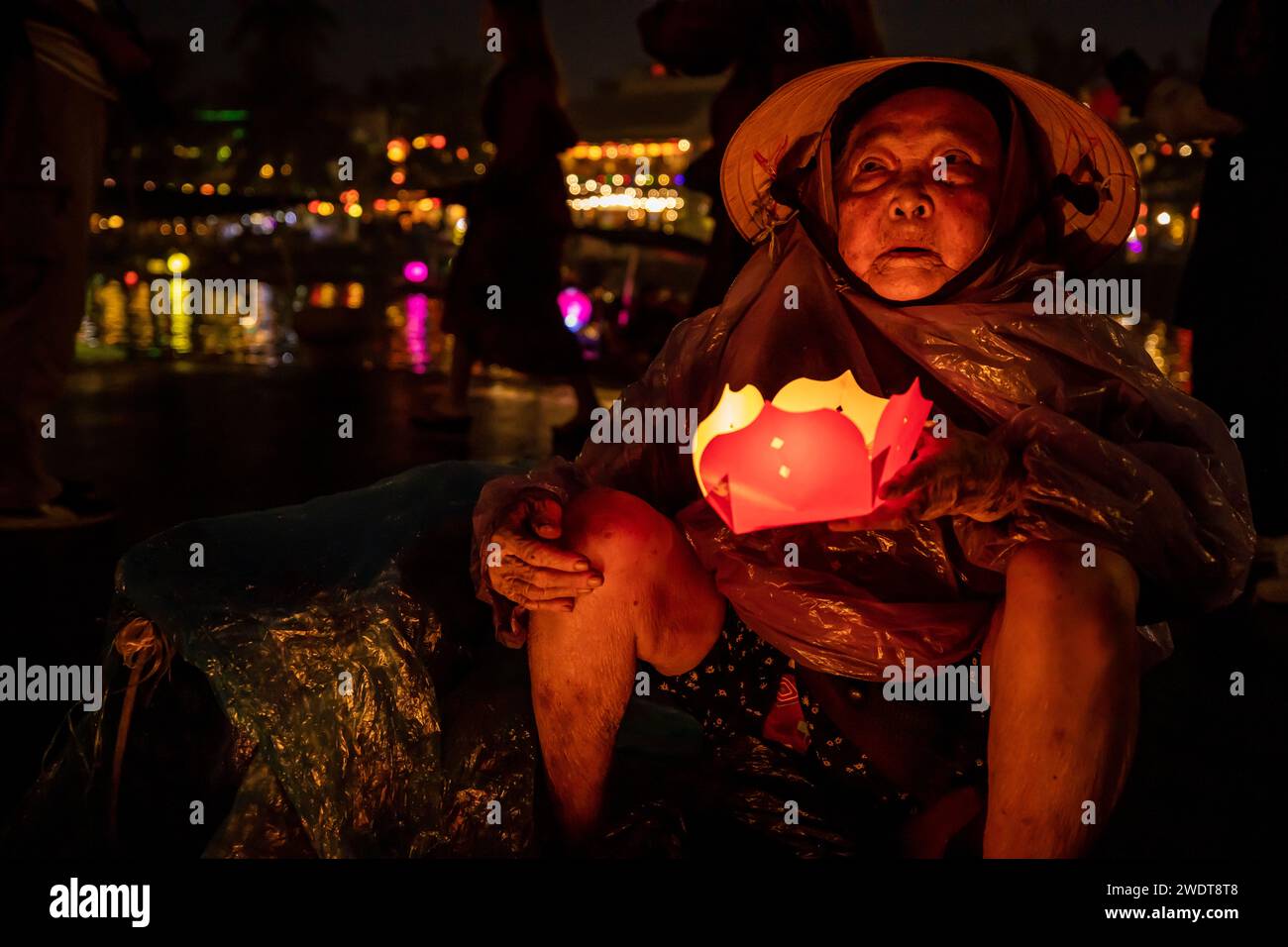 Old poor woman is selling lantern and candles in Hoi An Vietnam Stock ...