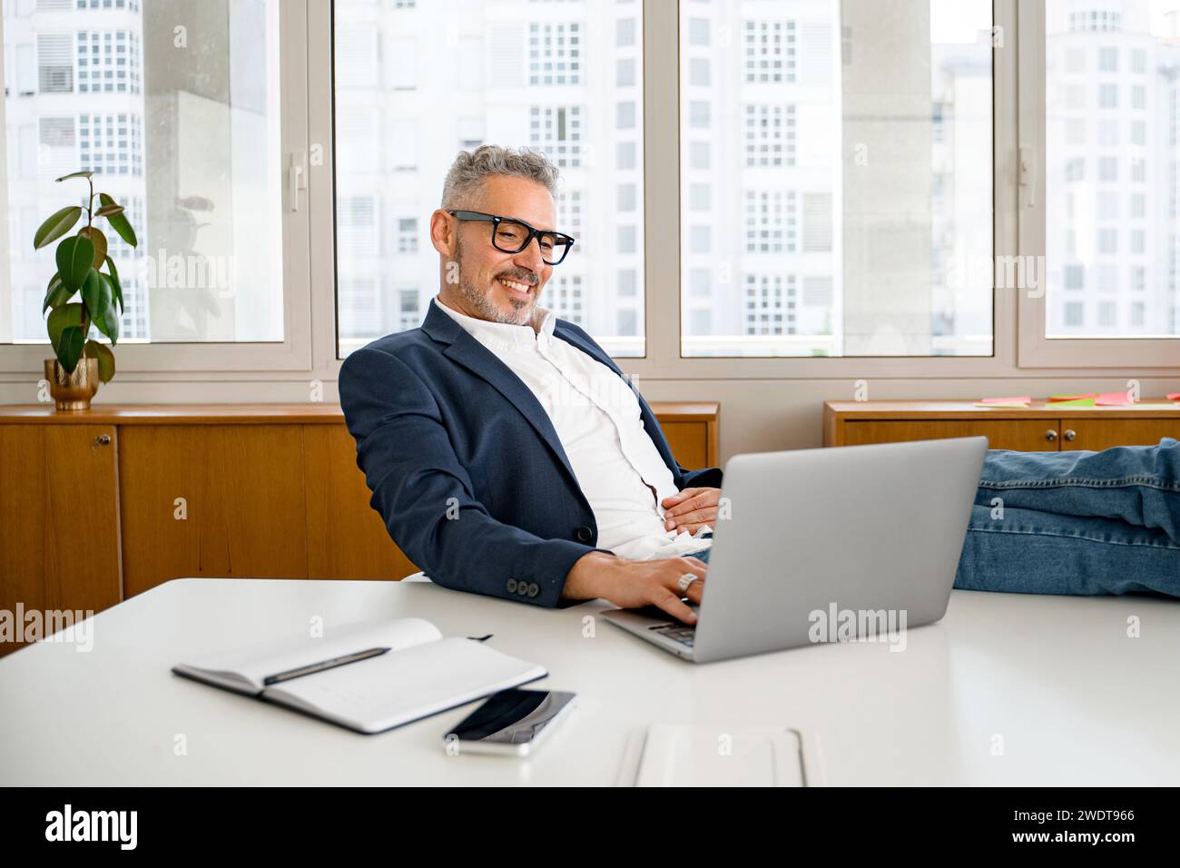 Self-assured 60s gray-haired modern confident businessman working in a ...