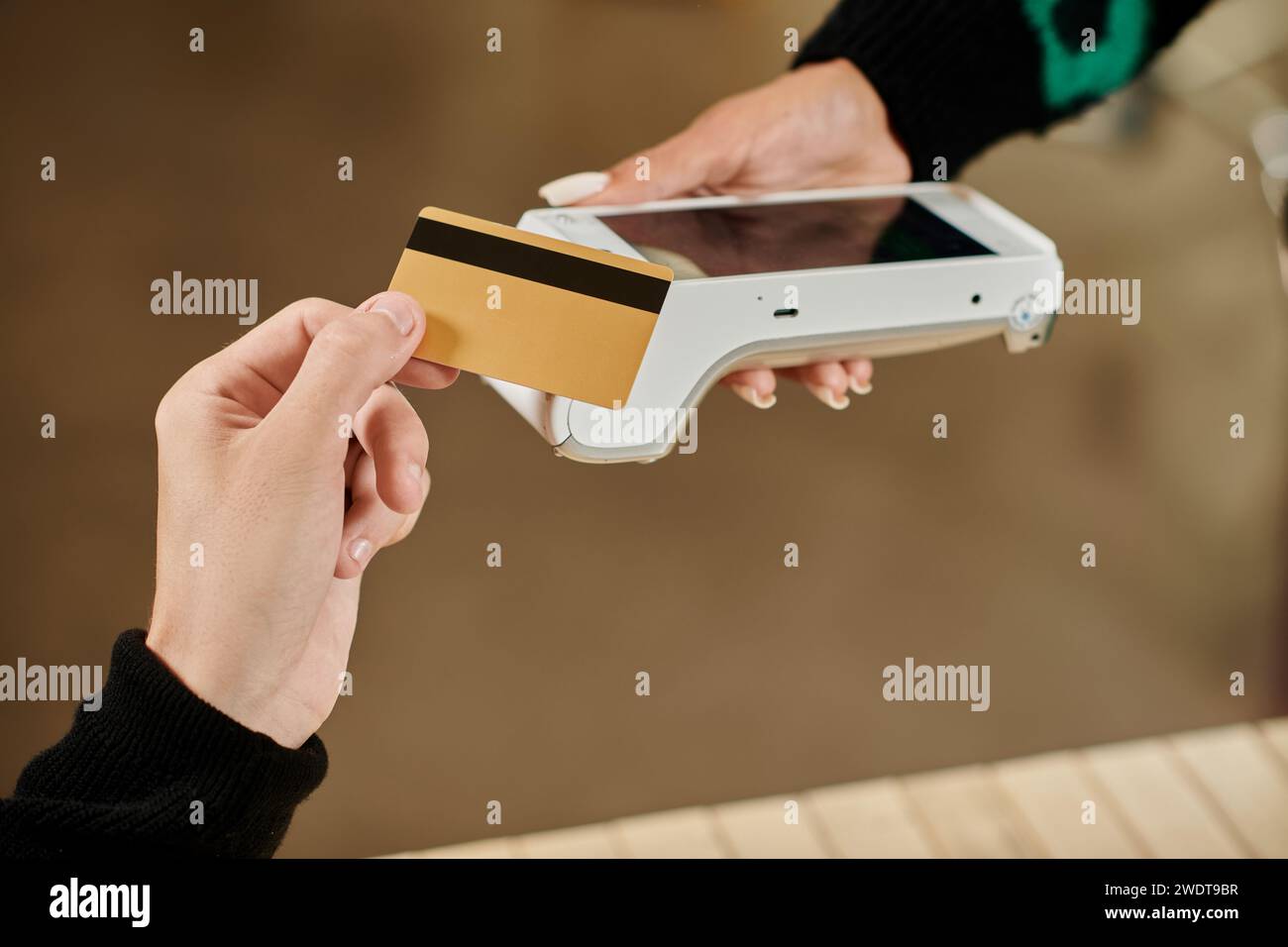 customer holding credit card near contactless card reader, cropped hand ...