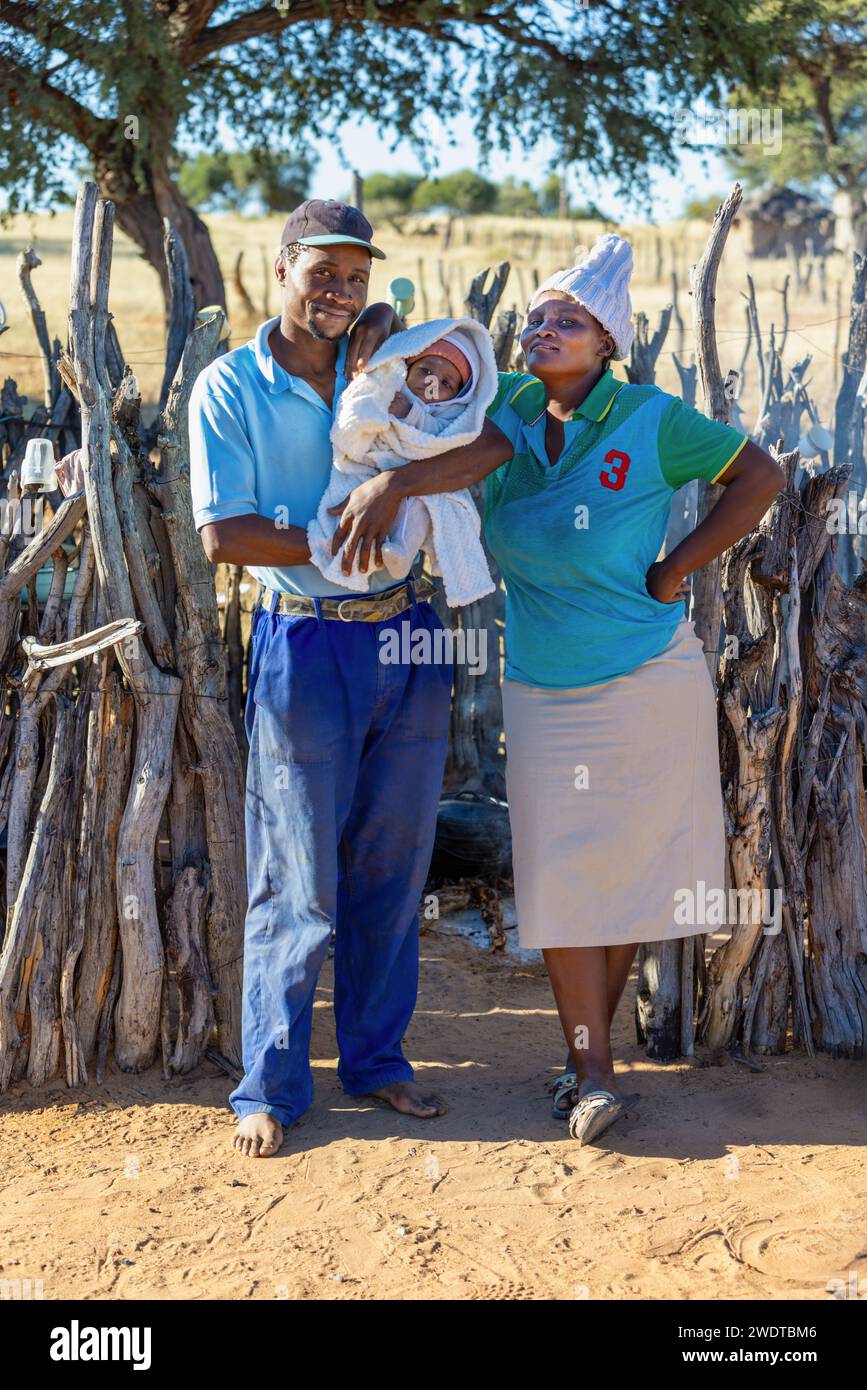 joyous african parents holding their new born baby, outdoors kitchen in ...