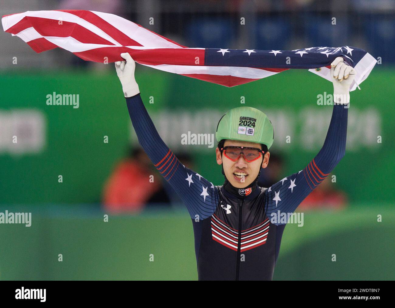 Winner Sean Boxiong Shuai of the U.S. celebrates with the national flag ...