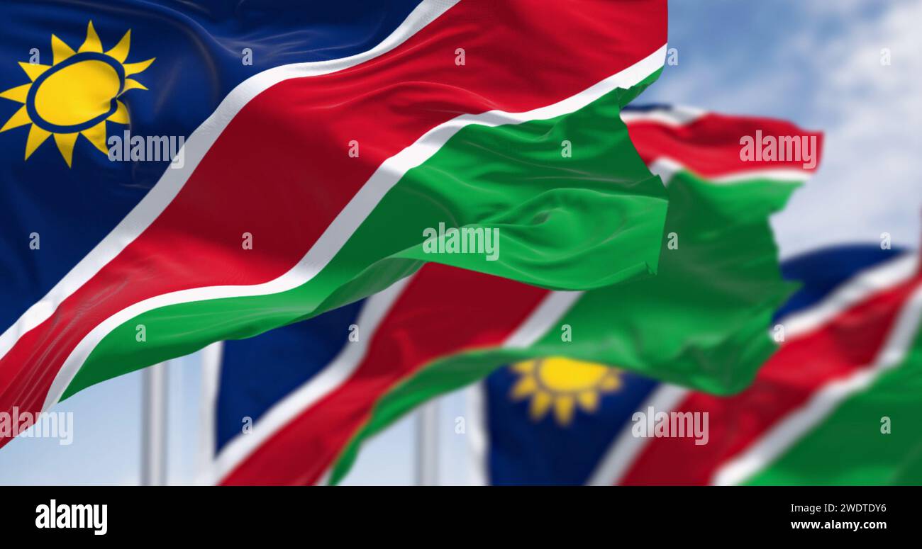 Namibia national flags waving on a clear day. Blue stripes, yellow sun ...