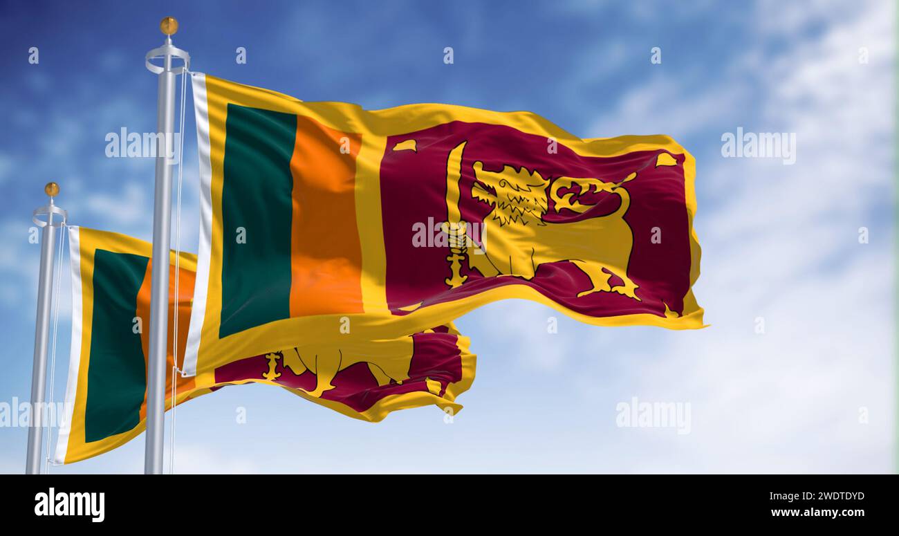 Two Sri Lanka national flags waving on a clear day. island country in ...