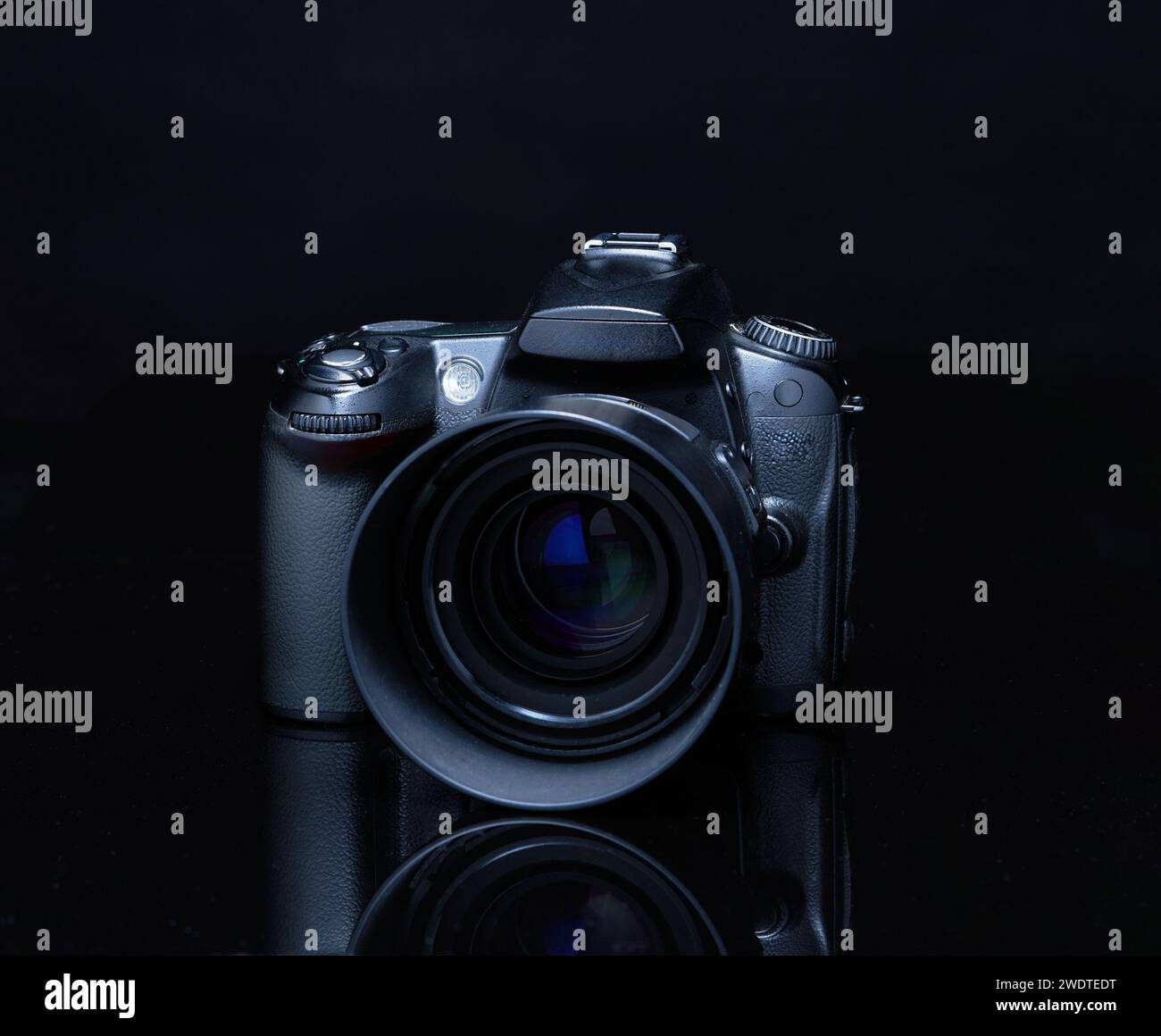 DSLR camera with lens attached, photographed with a black on black ...