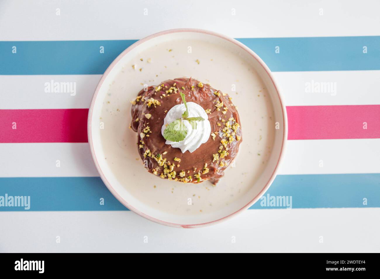 Top shot of a three milk layered tres leches pancake with nuts and ...