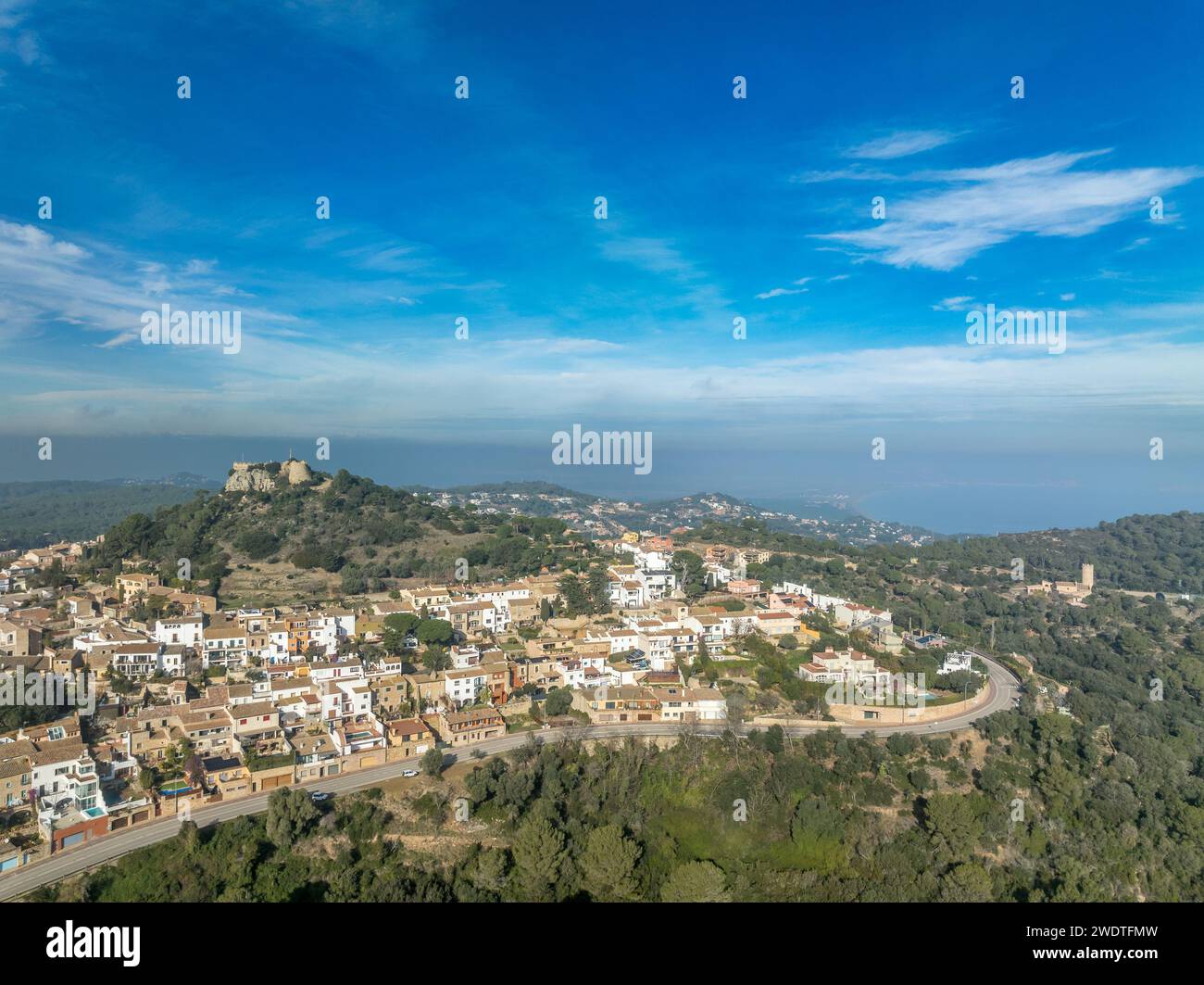 Remains of a 16th-century Begur castle fort atop a forested hill, with ...