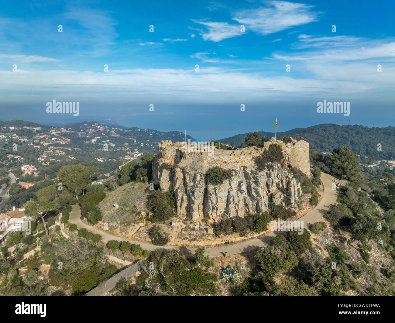 Remains of a 16th-century Begur castle fort atop a forested hill, with ...