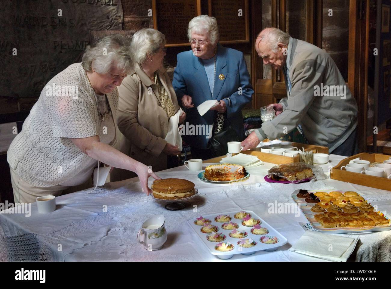 Home made cakes and tea being set out in village church vestry. English ...