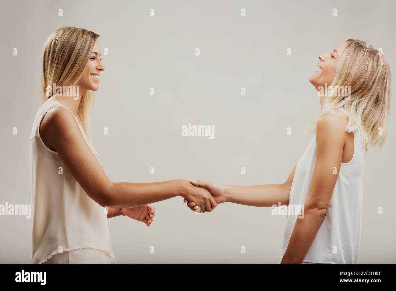 Smiles and a spirited handshake demonstrate the fun-loving nature of ...