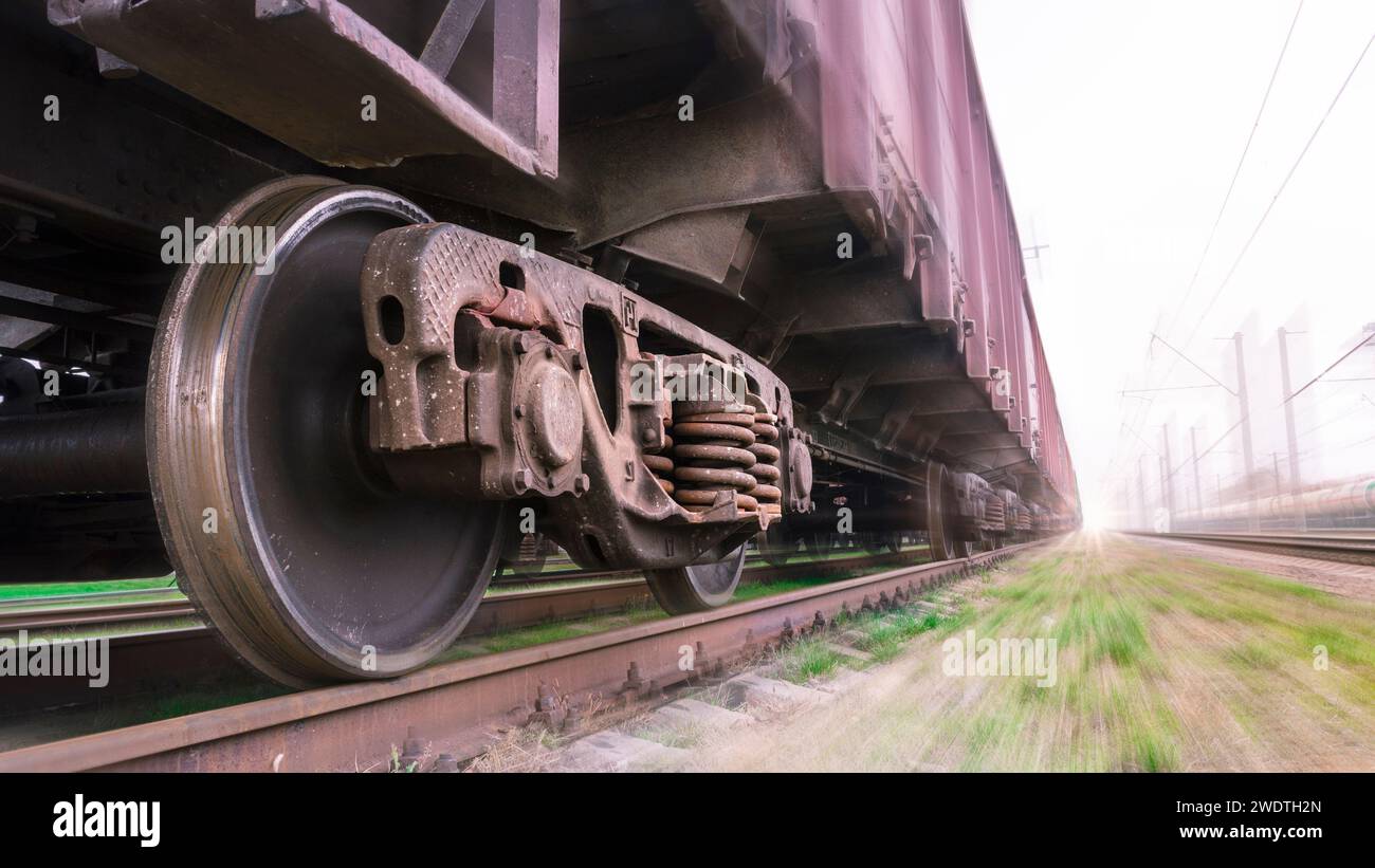 Heavy freight train moving fast on the railroad. The feeling of movement due to the blurred ...