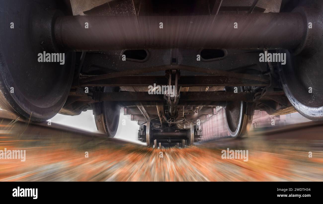 View from under the train traveling fast by rail. Wheels of a freight ...
