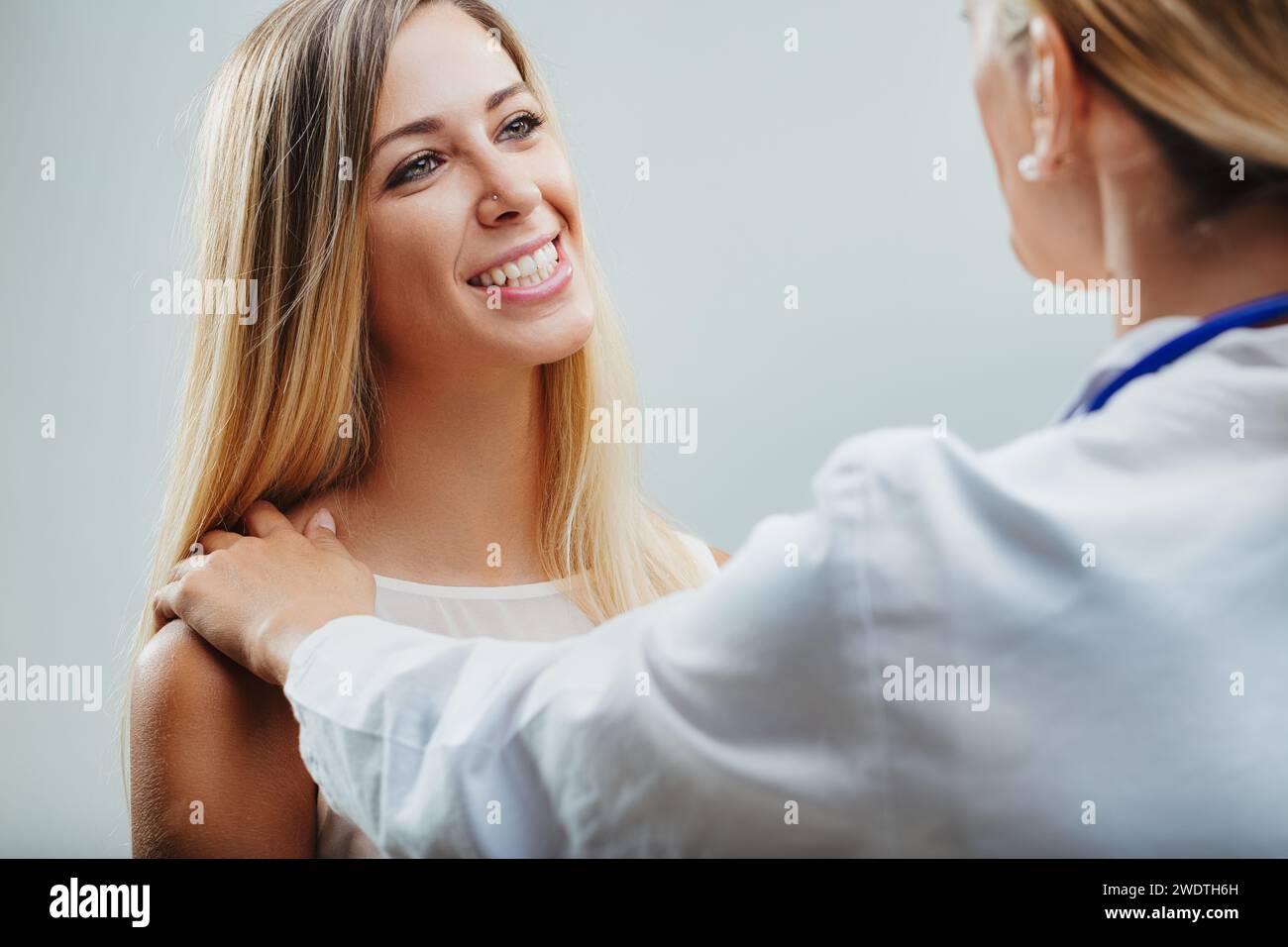 Comforting medical appointment, patient smiles brightly as the doctor ...