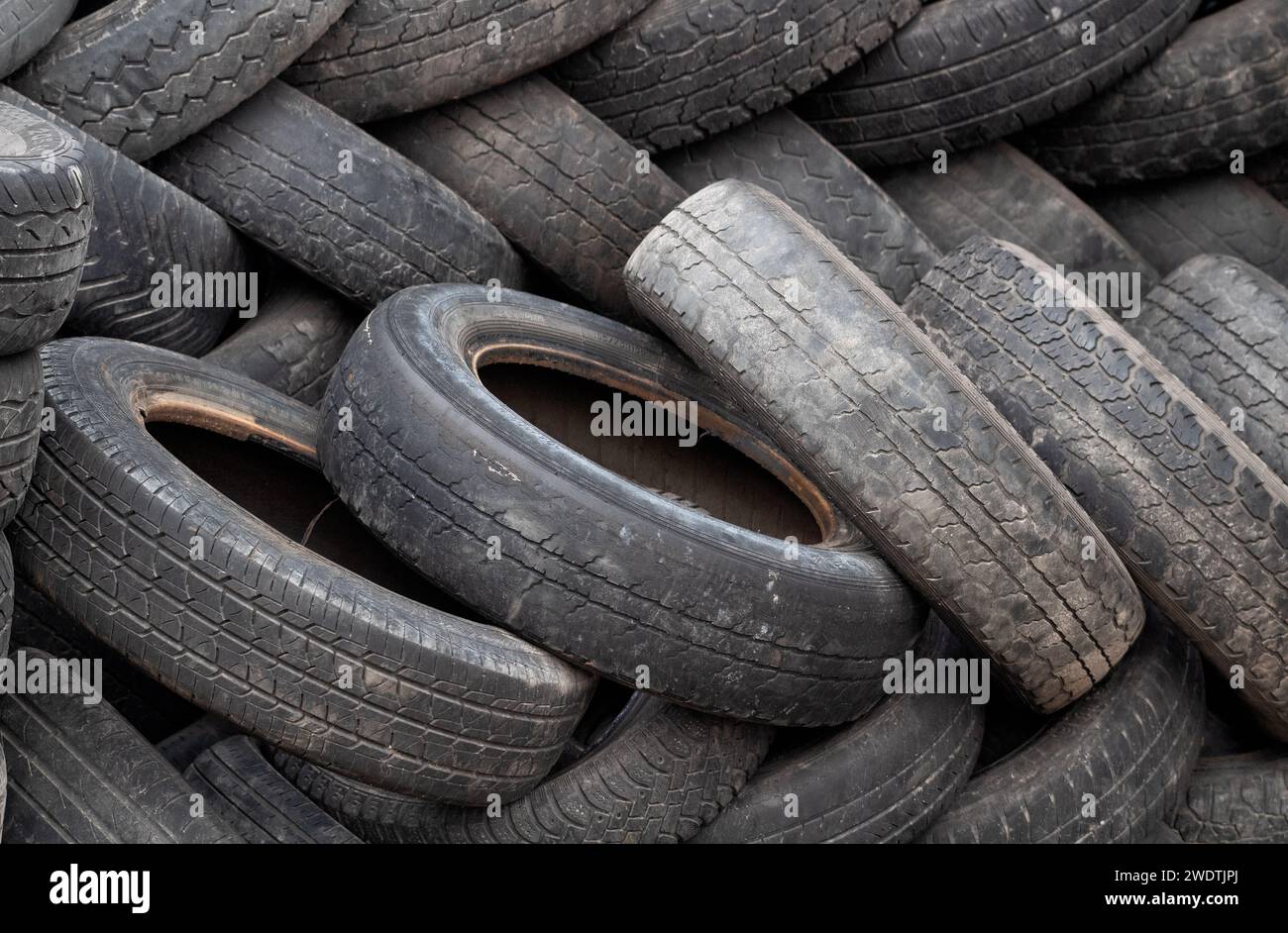 A bunch of dump tires from used cars. Environmental pollution. Old ...