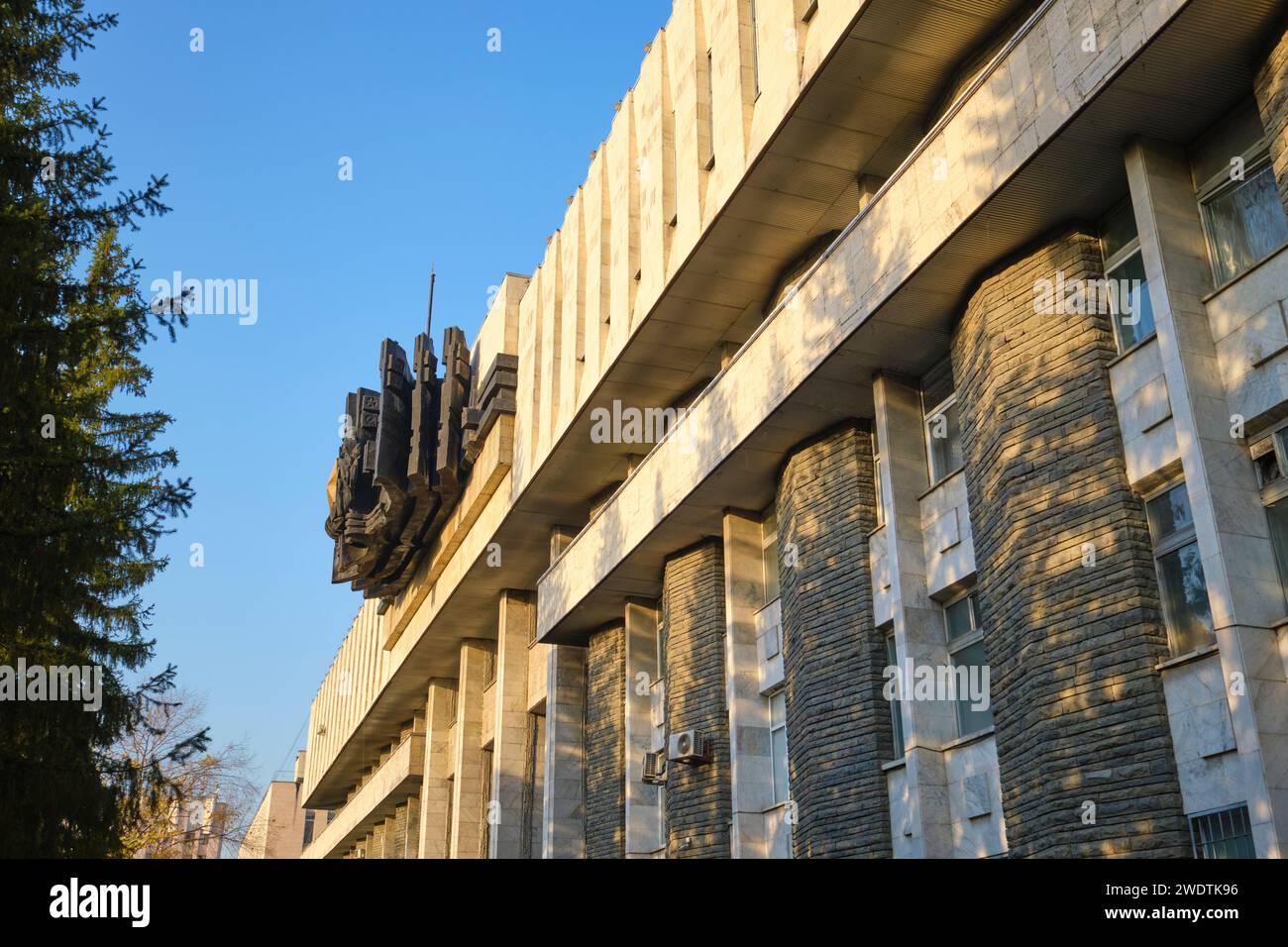 Front facade and a bronze socialist, modernist Soviet, Russian era ...