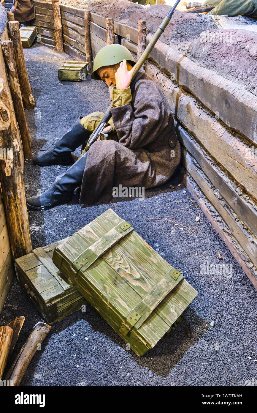Detail of a Soviet, Russian soldier taking cover in a dug out trench ...