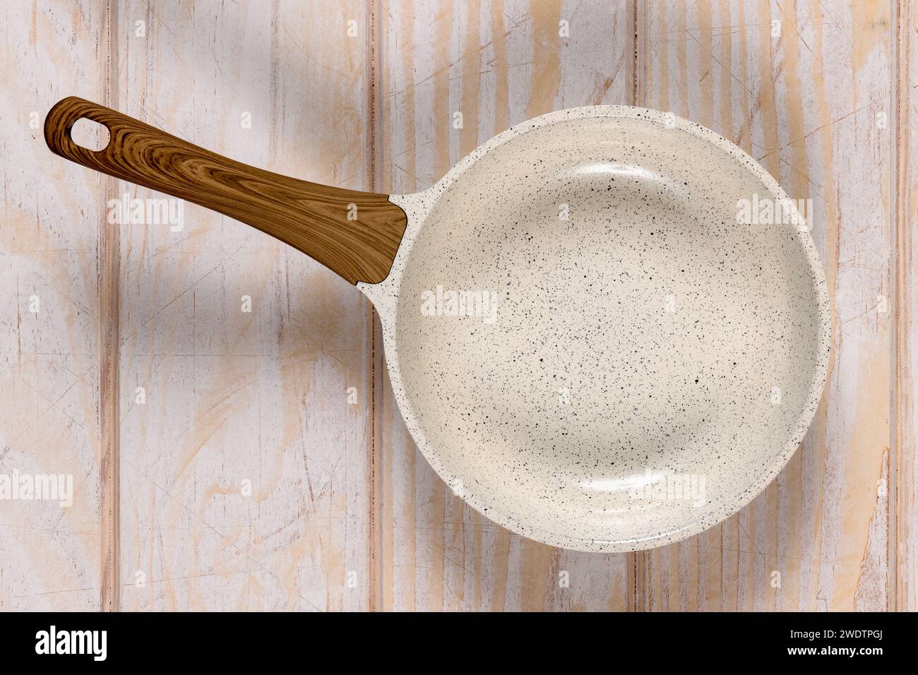Round fry pan on a weathered white wood texture background. Non-stick ...