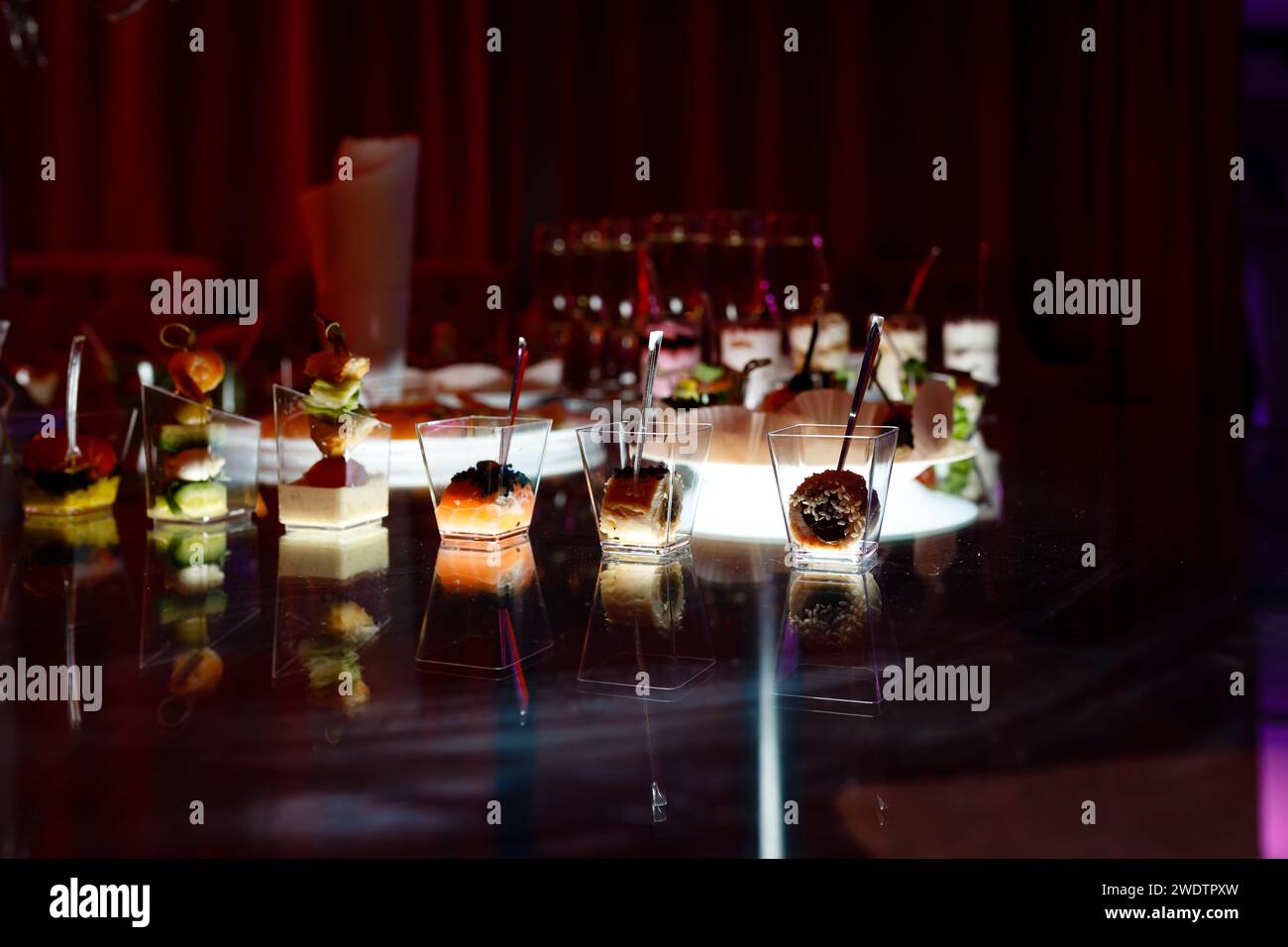 buffet table with toasts and snacks and desserts in red tones. High ...