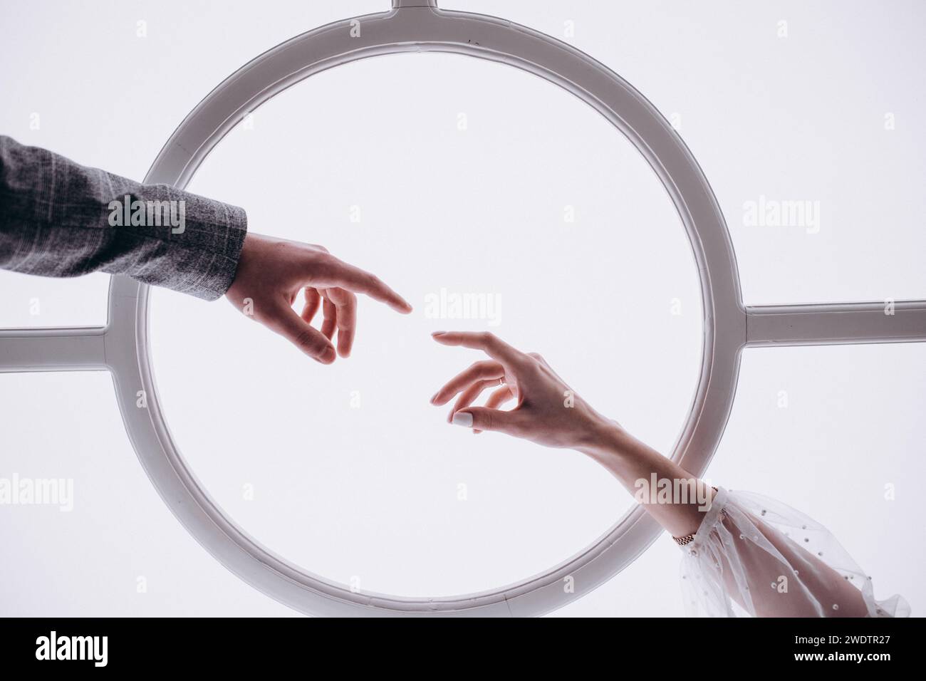 hands reach out to each other on a light background. High quality photo ...