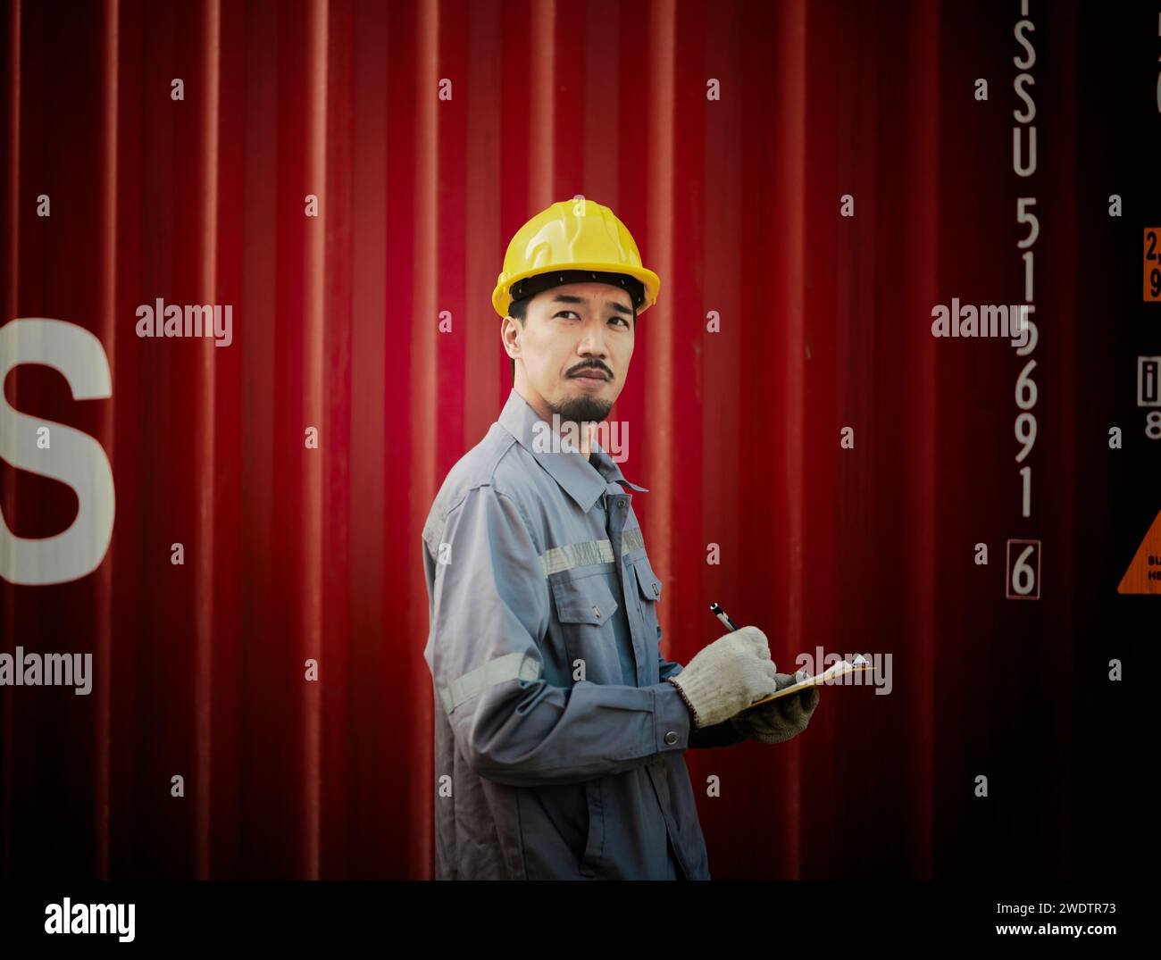 Engineer OR Worker is writing and check on checklist document during safety audit and inspection ...