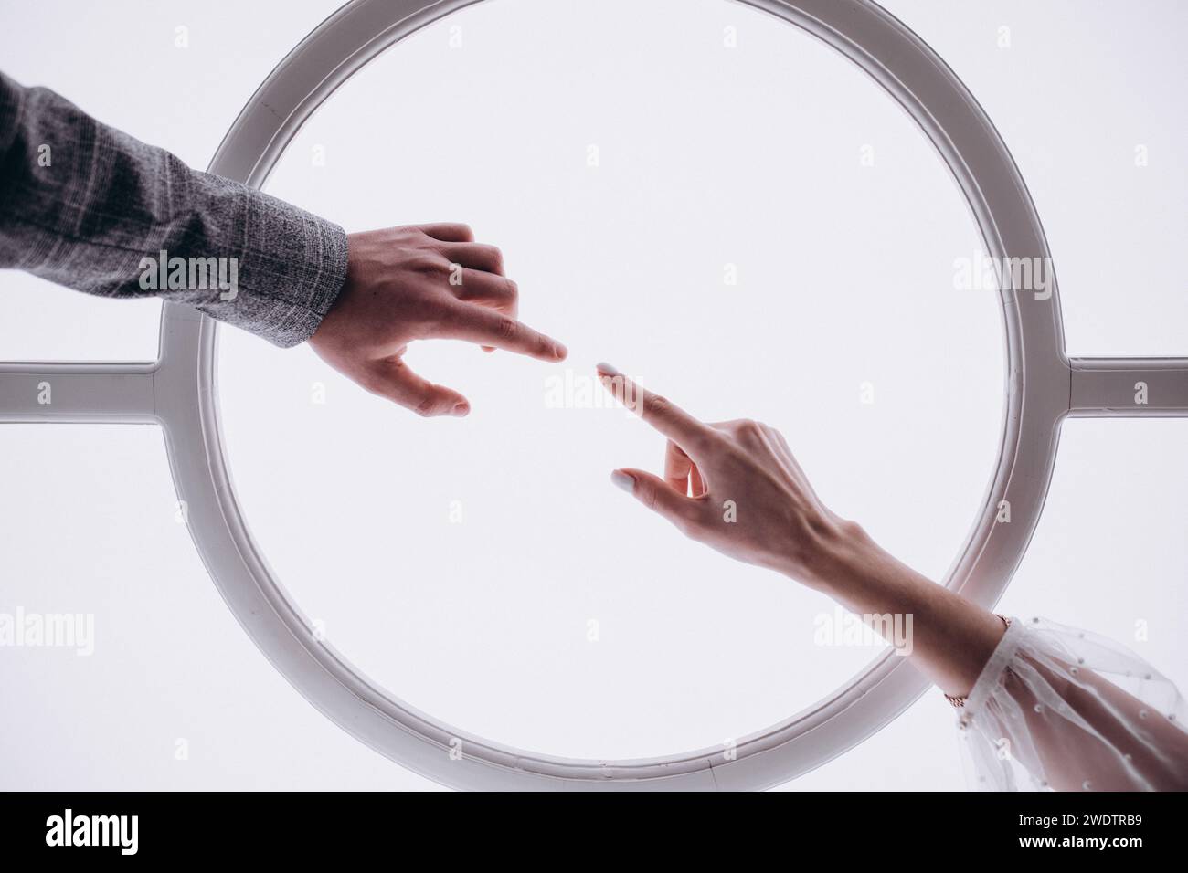 hands reach out to each other on a light background. High quality photo ...