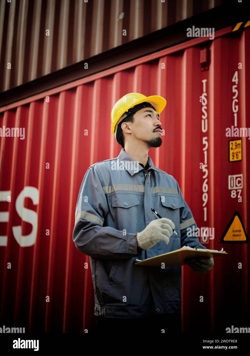 Engineer OR Worker is writing and check on checklist document during safety audit and inspection ...