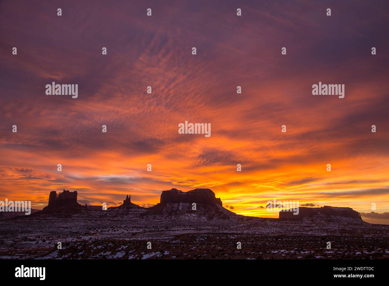 Colorful sunset skies over the Utah monuments in the Monument Valley ...