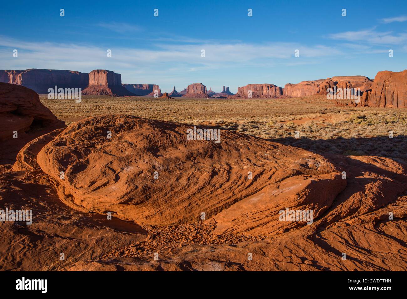 A sculpted sandstone boulder in front of the monuments in the Monument ...