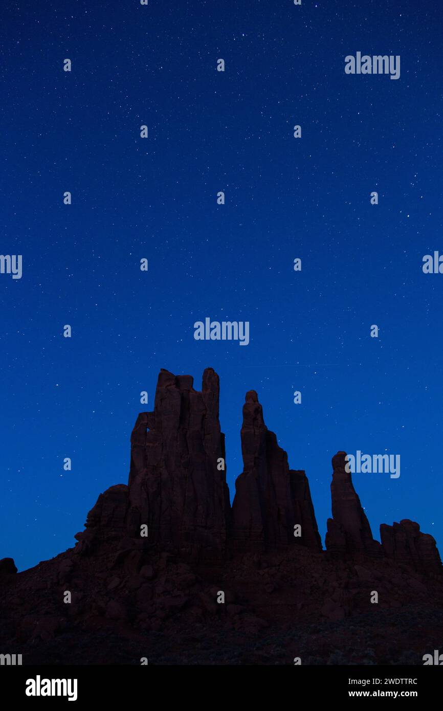 Stars over the moonlit Yei Bi Chei at night in the Monument Valley ...
