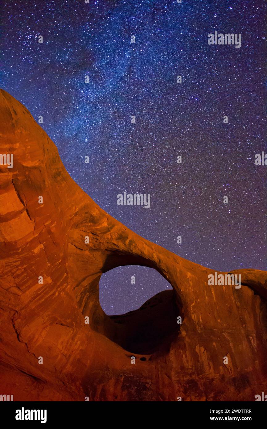 The Milky Way over Moccasin Arch at night in the Monument Valley Navajo ...