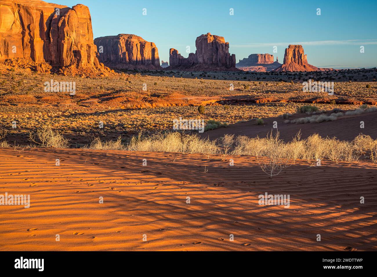 Red sand dunes and sandstone monuments in the Monument Valley Navajo ...