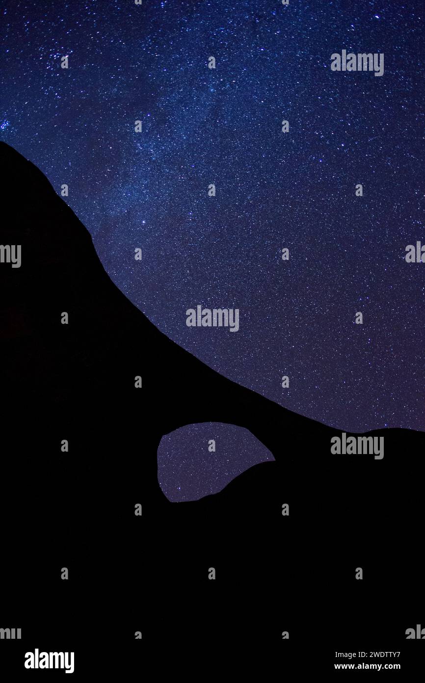 The Milky Way over Moccasin Arch at night in the Monument Valley Navajo ...