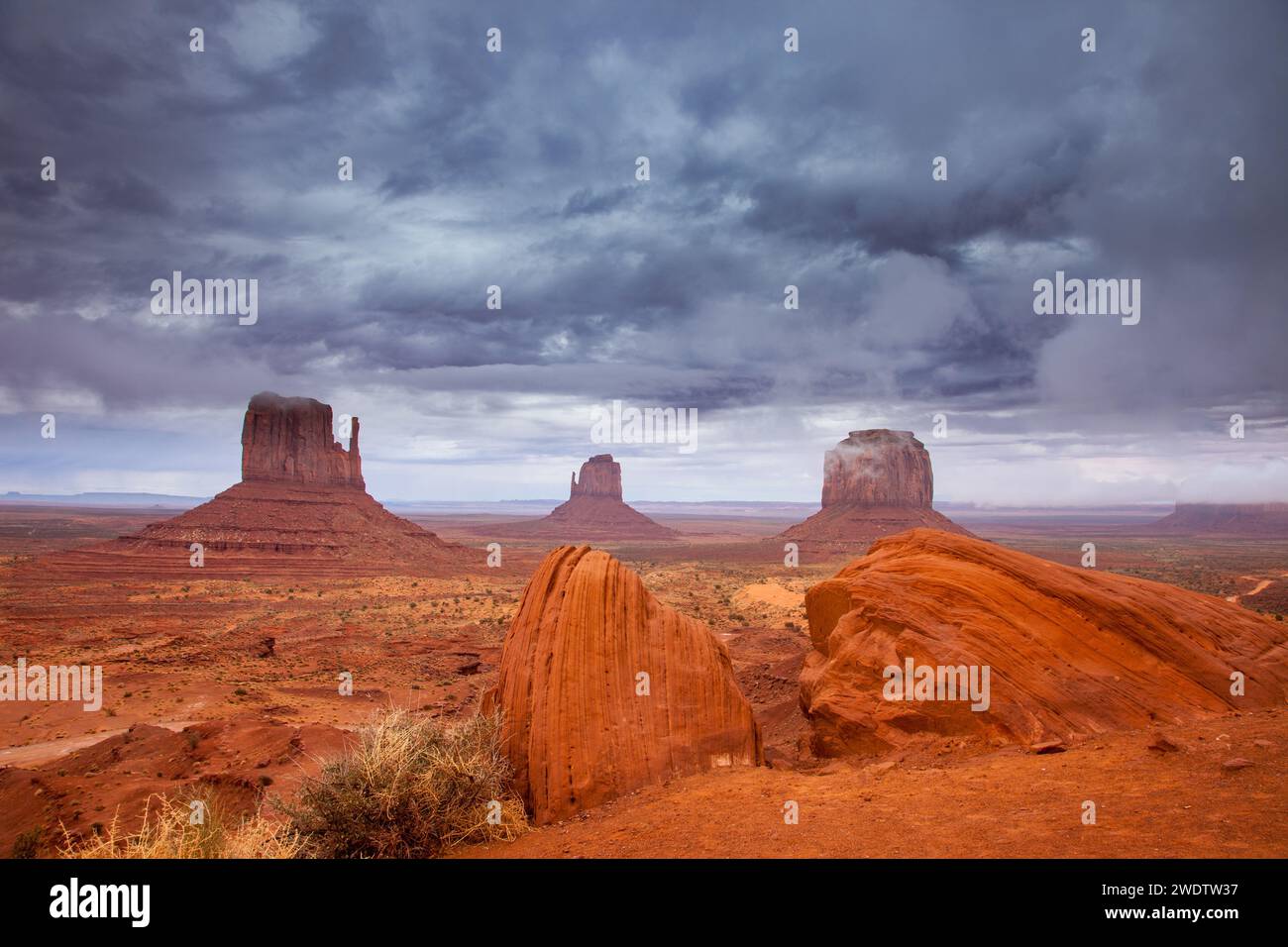Stormy skies over the Mittens and Merrick Butte in the Monument Valley ...