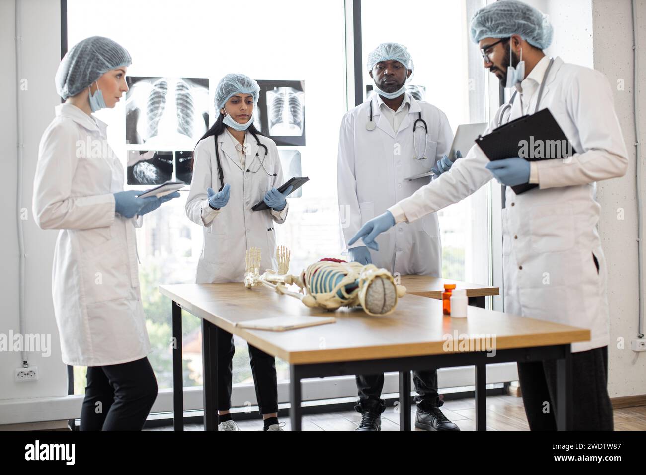 Indian woman teaching anatomy to university students or young doctors ...