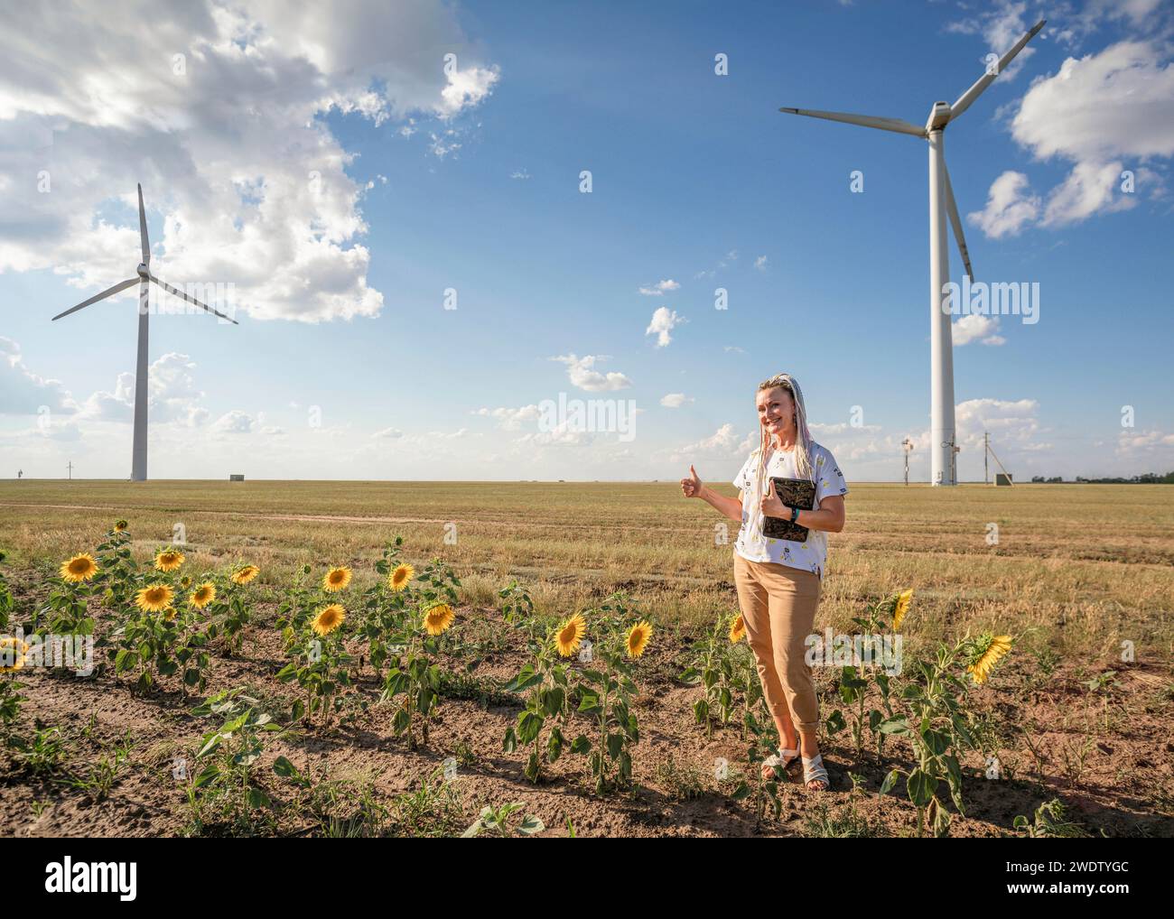 smiling blogger girl with bright braids shoots a story about green ...