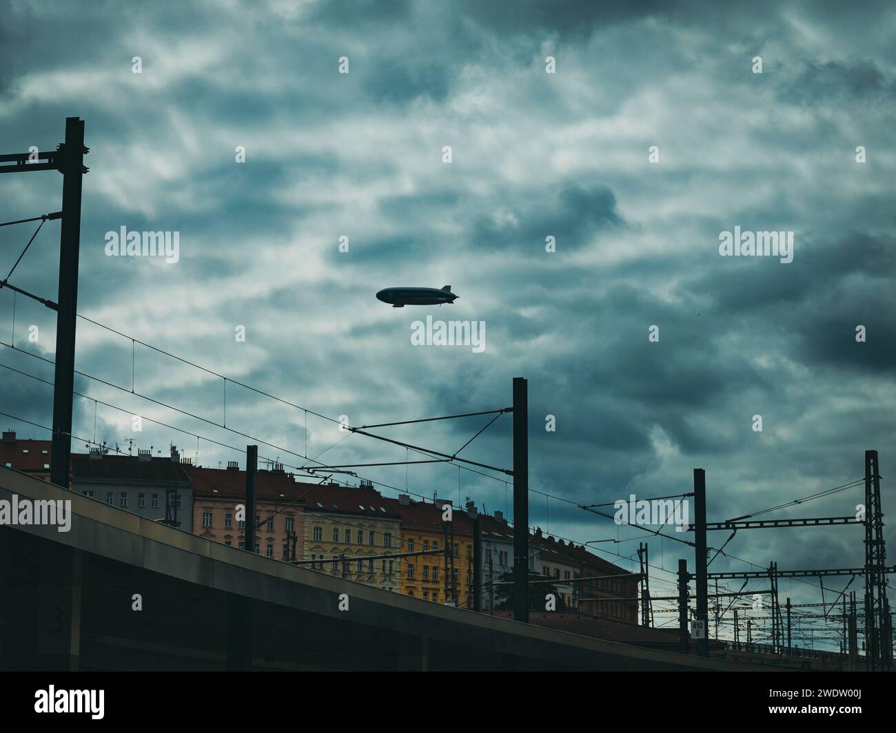 silhouette of an airship flying over the city Stock Photo - Alamy