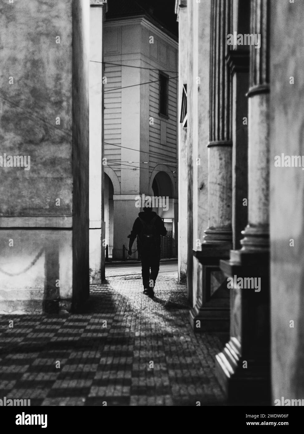 lone man in old town at night Stock Photo - Alamy