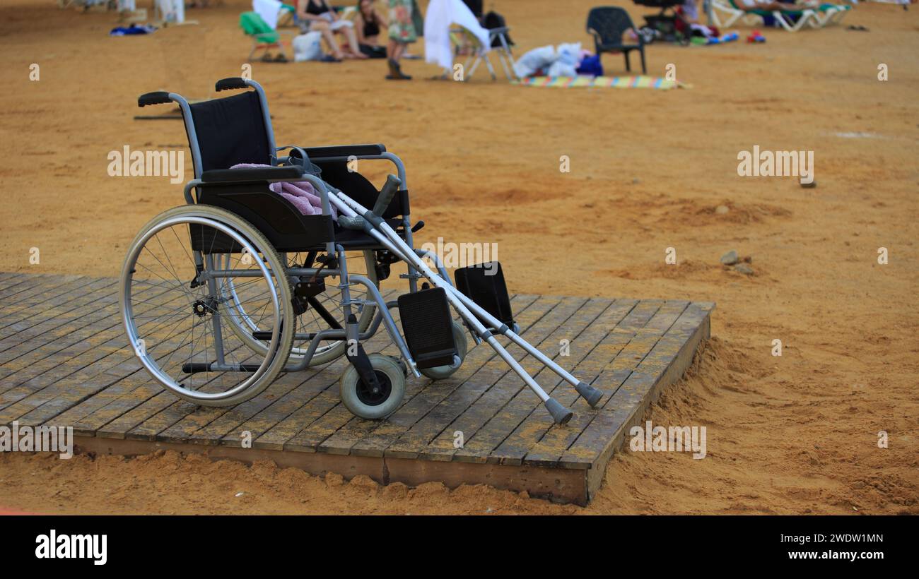 wheelchair and crutches on a sandy beach. High quality photo Stock ...