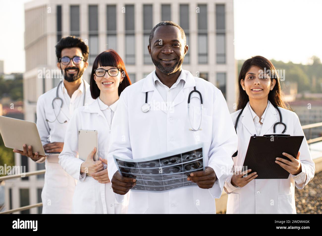 Potrait of medical workers using gadgets while examining results of x ray scan Stock Photo - Alamy