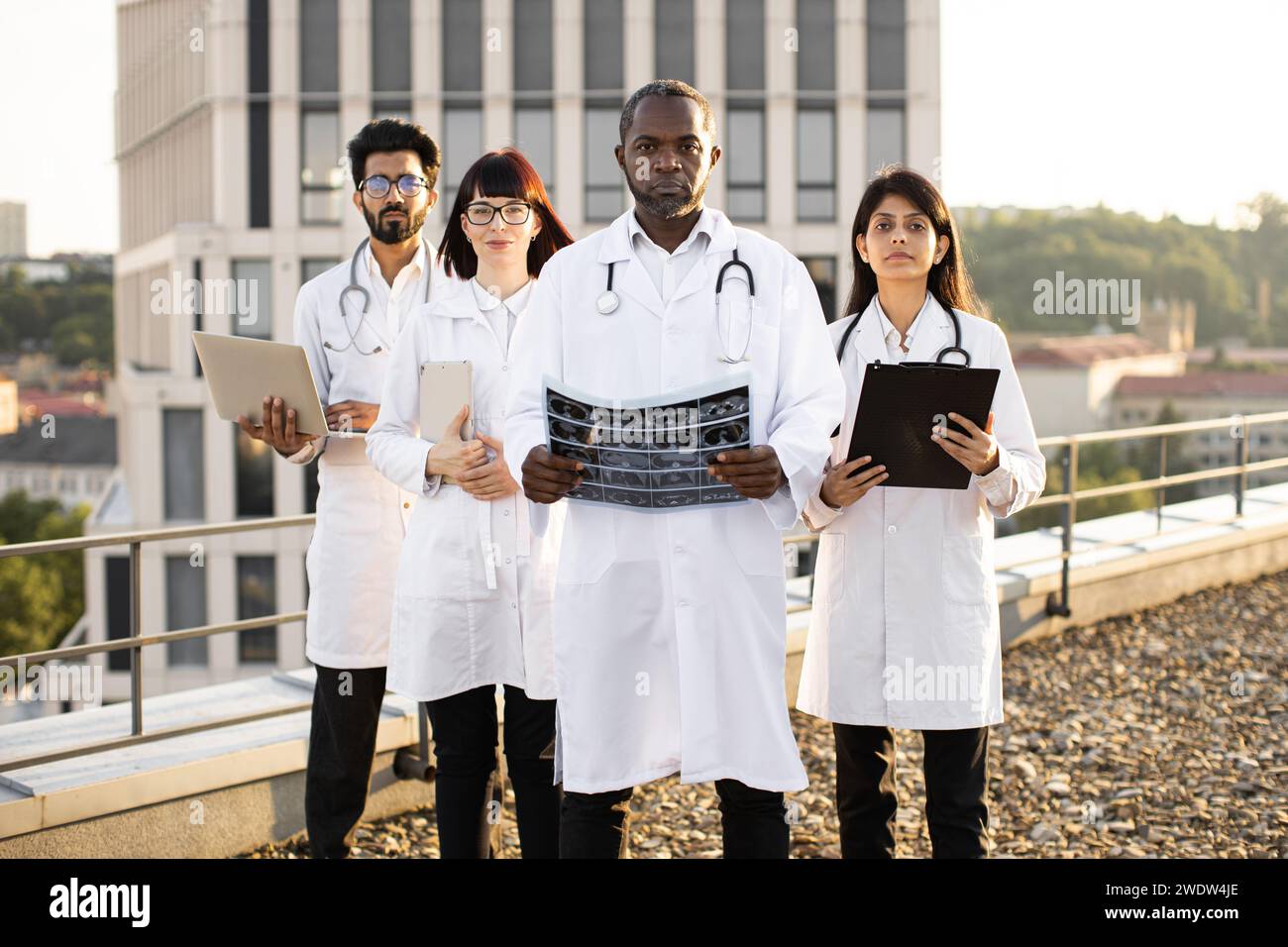 Potrait of medical workers using gadgets while examining results of x ...