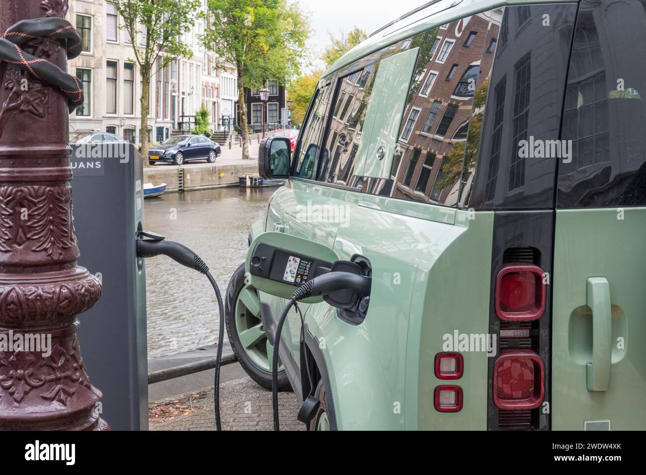 Electric plug-in hybrid Land Rover Defender charging on the canal side ...