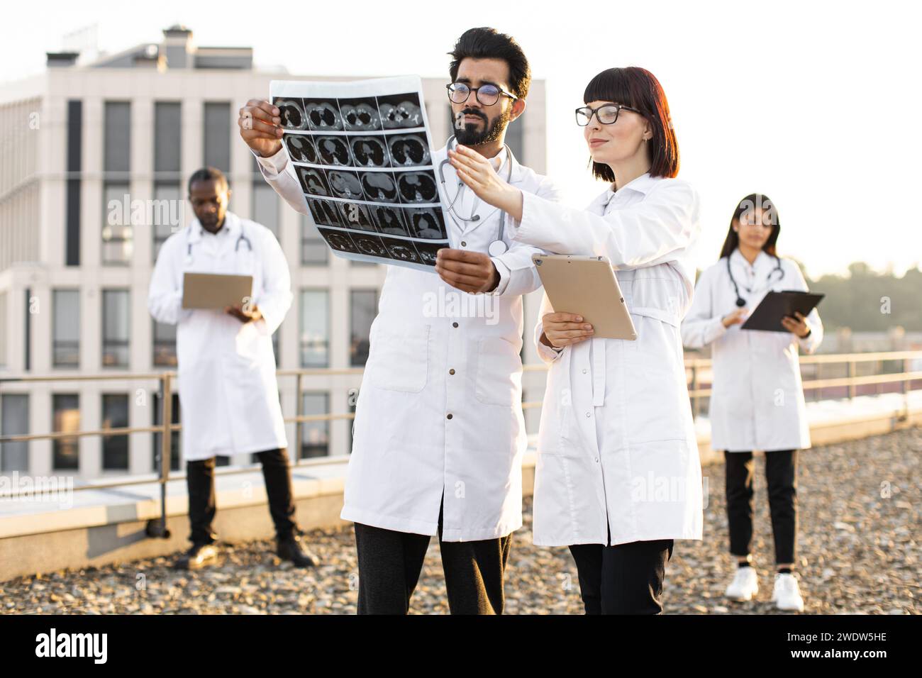 Medical workers talking about patient examination results Stock Photo ...