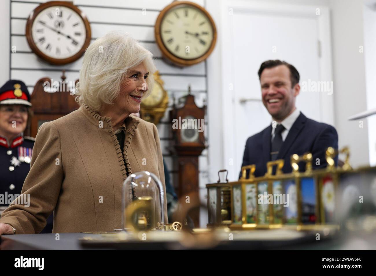 Queen Camilla views a selection of carriage clocks during a visit to Deacon & Son, one of the ...