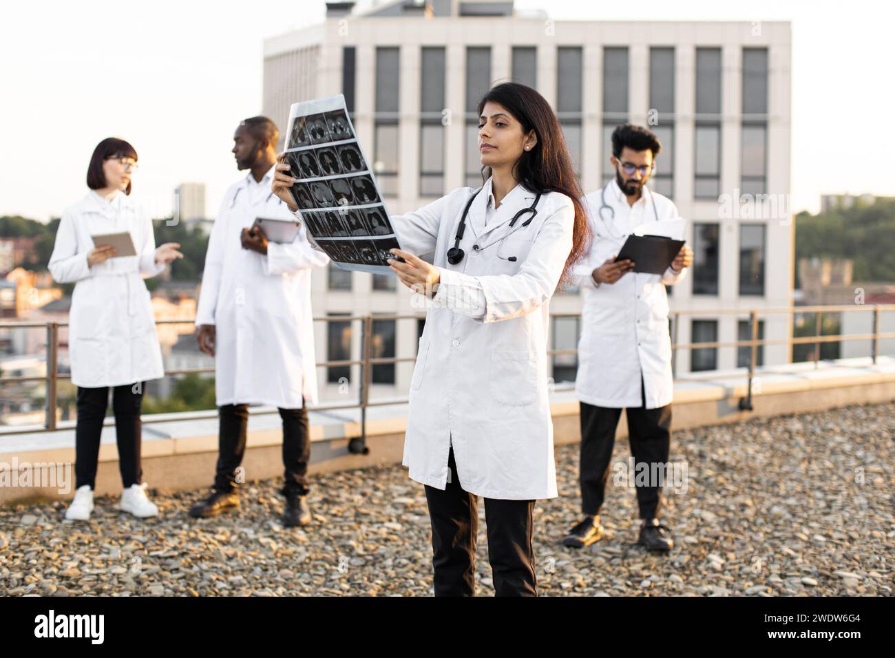 Doctor holding x-ray scan of patient during break outdoors hospital ...