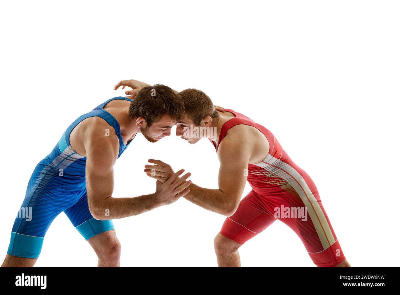 Young skilled wrestlers in blue and red uniform hand wrestling in ...